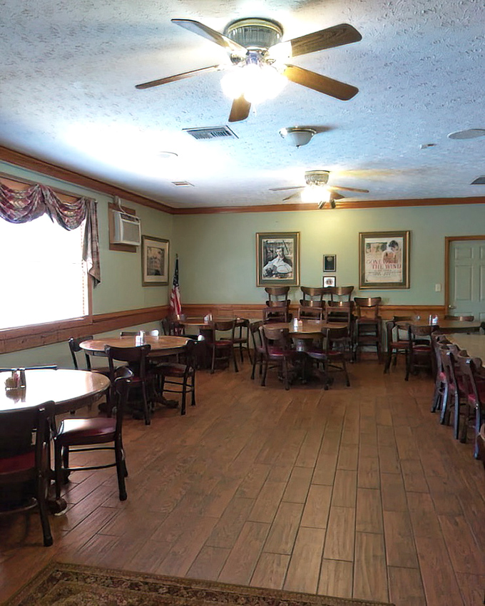 Step inside to a dining room where ceiling fans lazily spin above wooden tables, creating the perfect backdrop for unhurried conversations and hearty meals.