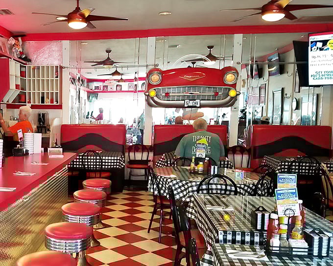 Step into a time machine disguised as a diner. The vintage car front, checkerboard floor, and red vinyl booths aren't retro chic—they're authentically, gloriously retro.