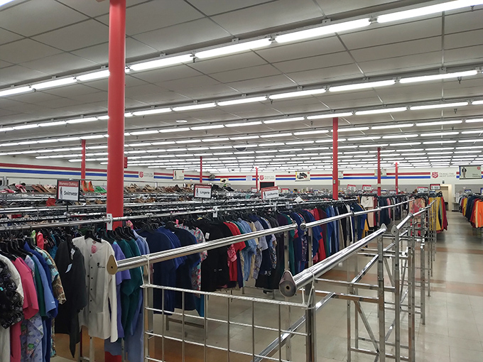 Rows of clothing stretch endlessly under fluorescent lights, creating a fashion lover's paradise where every rack holds possibilities.