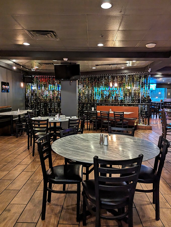 The dining room's warm wood tones and glimmering bottle display create that perfect "I've found my new favorite spot" ambiance.