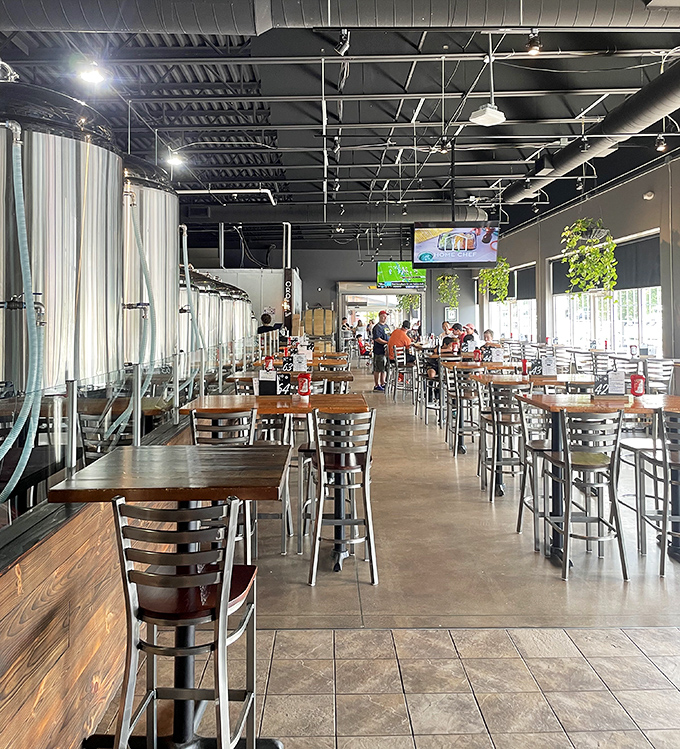 Industrial-chic meets cozy comfort in this spacious dining room where brewing tanks remind you that beer magic happens just steps away.