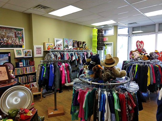 A rainbow of clothing racks greets shoppers, with stuffed animals standing guard over children's apparel like fuzzy sentinels of secondhand style.