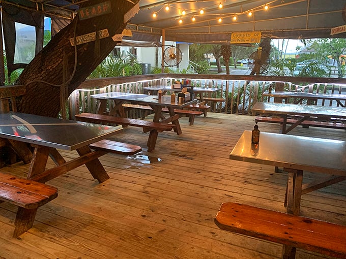 Picnic tables under string lights create that "I've discovered something special" atmosphere&mdash;part beach shack, part hidden gem, all charm.