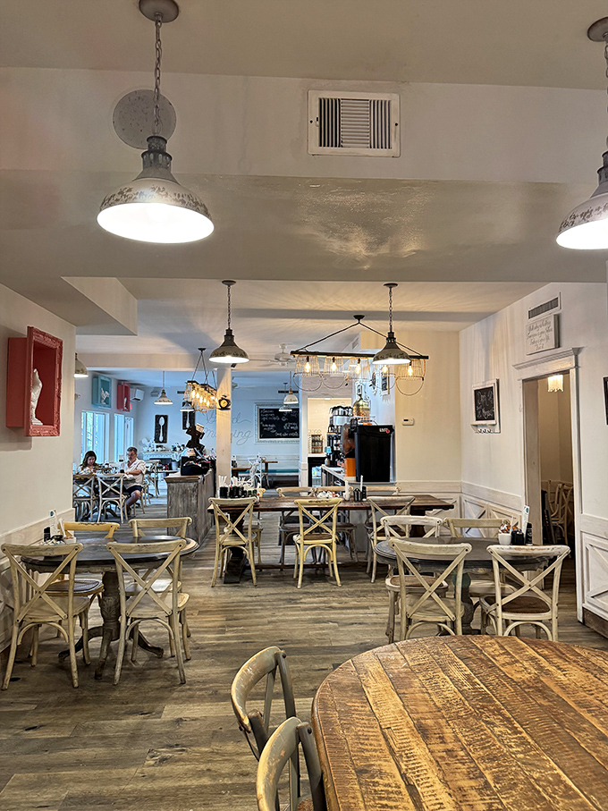 Step inside to a coastal-chic interior where farmhouse meets Florida &ndash; those cross-back chairs aren't just stylish, they're practically begging you to settle in for a third coffee.