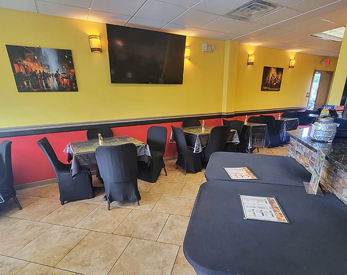 Yellow walls and black tablecloths create a warm, inviting atmosphere where comfort food meets strategic thinking. Your move: deciding what to order first.