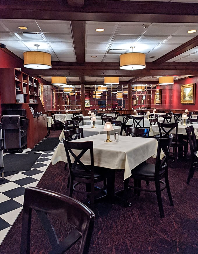 The dining room's classic steakhouse ambiance&mdash;burgundy walls, mirrored accents, and drum lighting&mdash;sets the stage for meat-centric memories in the making.