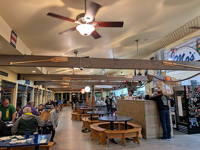 Rustic charm and nautical touches come together in this cozy eatery, where wooden beams and paddle-lined decor echo the spirit of seaside adventures.