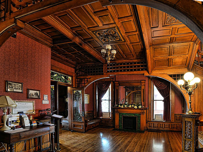 This isn't just woodwork—it's wooden poetry. The coffered ceiling and archways create a warm embrace that whispers tales of Gilded Age gatherings.