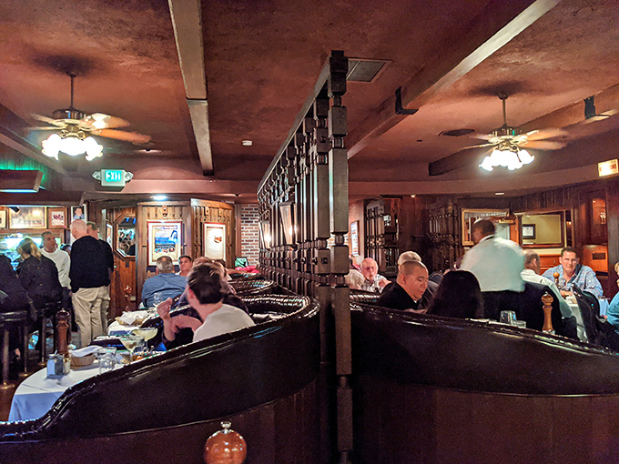 Dark wood booths, curved partitions, and the gentle hum of satisfaction&mdash;this is what steakhouse dreams are made of.