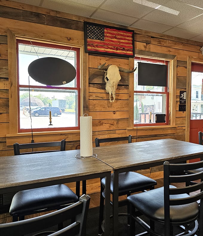 A rustic wooden interior that whispers "serious barbecue happens here" with its steer skull and American flag art.