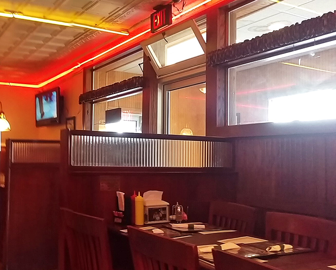 Wood paneling and cozy booths create that perfect small-town restaurant ambiance where conversations flow as freely as the coffee refills.