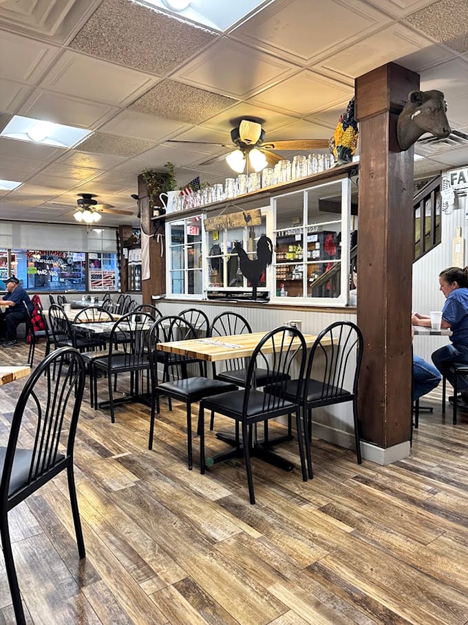 Simple wooden beams and black metal chairs create that perfect "grandma's kitchen" vibe where comfort food memories are made daily.
