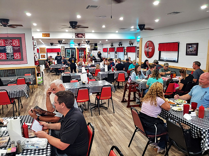 Inside, the classic black-and-white checkered tablecloths and red chairs create that perfect diner atmosphere where calories don't count and conversations flow as freely as the coffee.