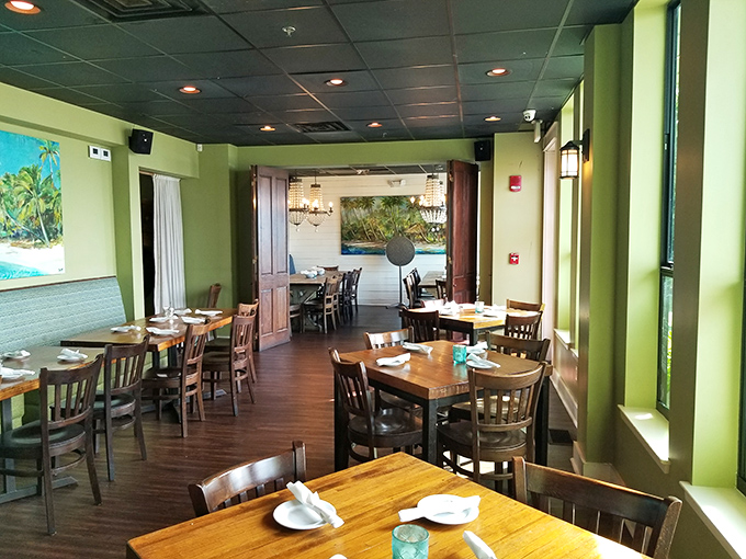 The interior's soothing green walls and warm wood tones create a tranquil escape that lets the ocean views remain the star attraction.