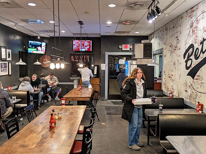 Inside Beto's, wooden tables and exposed brick create the perfect backdrop for pizza conversations that inevitably begin with "Wait, the cheese is cold?"