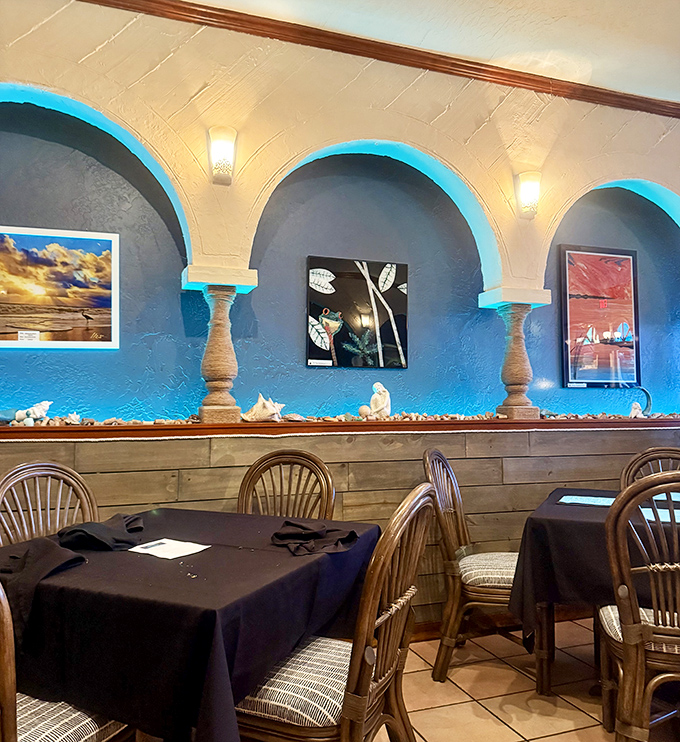 Blue arches frame local artwork like ocean waves, creating a dining atmosphere that's both sophisticated and as relaxed as a beach day.