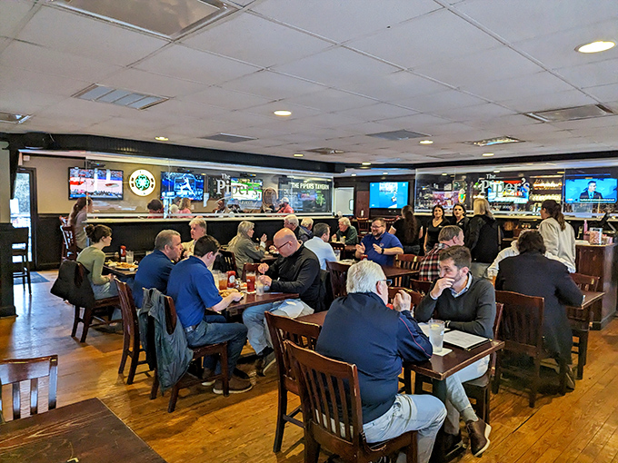 The buzz of conversation mingles with clinking glasses as wooden chairs cradle patrons enjoying that perfect blend of neighborhood charm and genuine hospitality.
