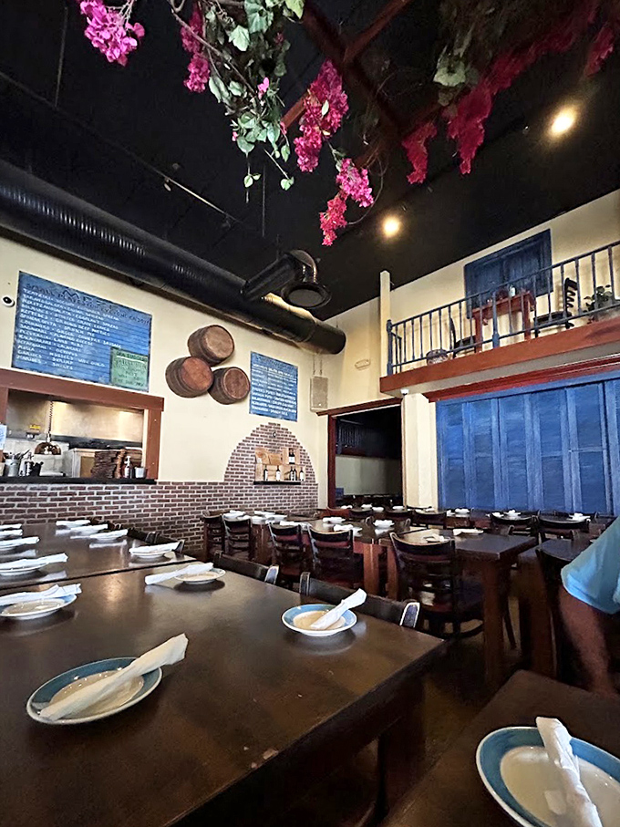 Step inside and you're transported to a Greek island taverna, complete with hanging bougainvillea and rustic wine barrels that whisper stories of Aegean celebrations.