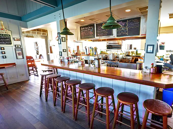 Pull up a stool at the counter and watch seafood magic happen. The blue ceiling? That's just the ocean sneaking indoors.