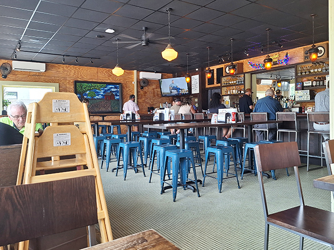 Inside, blue metal stools and warm wood paneling create that perfect "fancy enough but not too fancy" burger joint vibe.