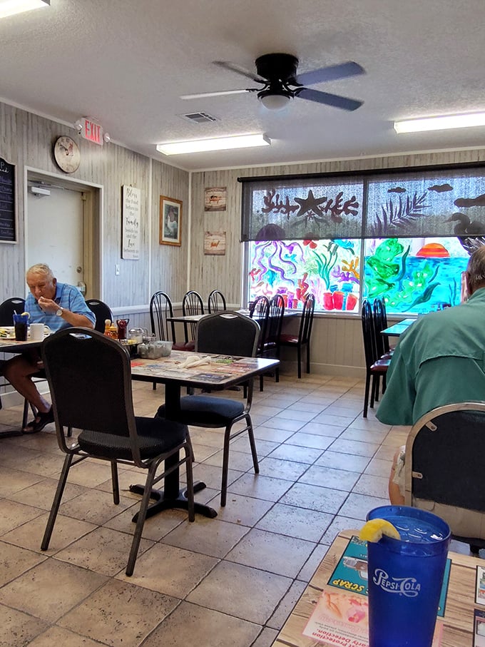 Simple, unpretentious interiors with hand-painted underwater scenes on the windows—because nothing says "Florida dining" quite like ocean views with your chicken.