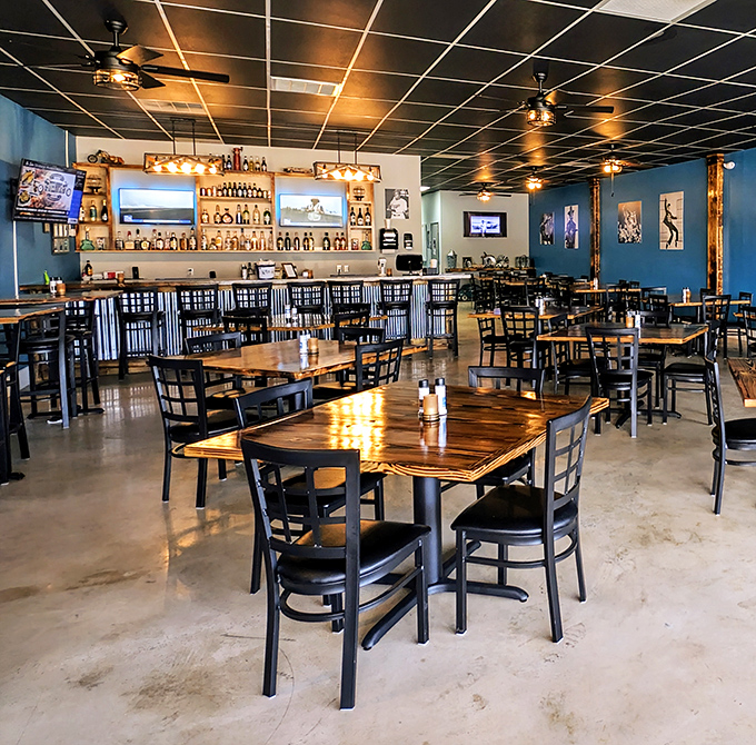 Rich wooden tables against cool blue walls create that perfect "fancy but not fussy" atmosphere where you can relax while your taste buds celebrate.