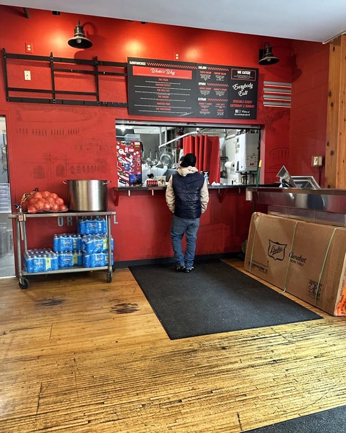 Simple red walls and a no-nonsense menu board&mdash;proof that the best places put their energy into the food, not fancy decorations.