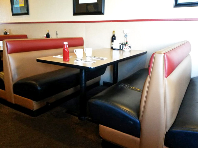 Classic diner booths where comfort meets nostalgia. These red and cream seats have cradled thousands of satisfied customers through countless meals.