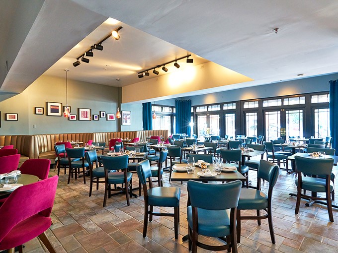 Plush blue chairs and vibrant pink accents create a dining room that's both sophisticated and welcoming&mdash;like your stylish friend's living room, if your friend could cook like a Mumbai master chef.