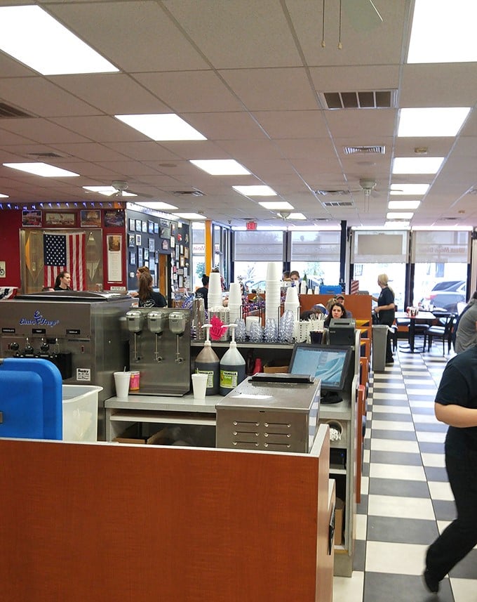 Classic black and white tiles lead you through a diner where time stands deliciously still. The American flag reminds you: breakfast is patriotic duty.