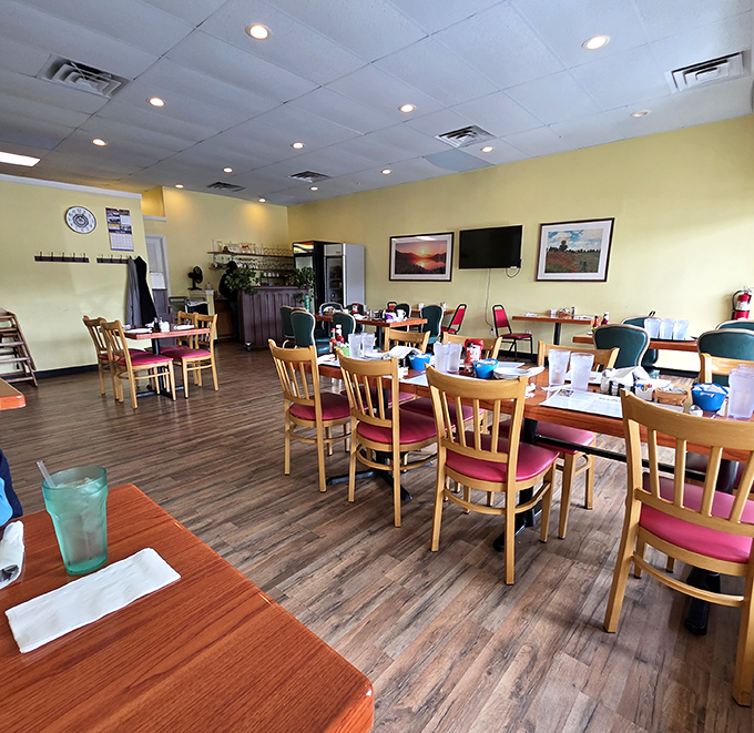 Yellow walls and wooden chairs create the perfect canvas for breakfast artistry. This dining room isn't trying to impress you&mdash;until the food arrives.