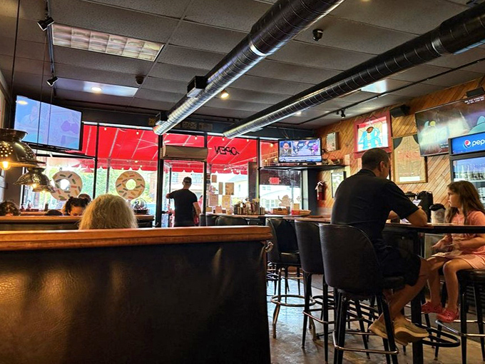 Wood-paneled walls and exposed ductwork create that perfect "industrial-cozy" vibe where breakfast dreams come true and coffee cups never empty.