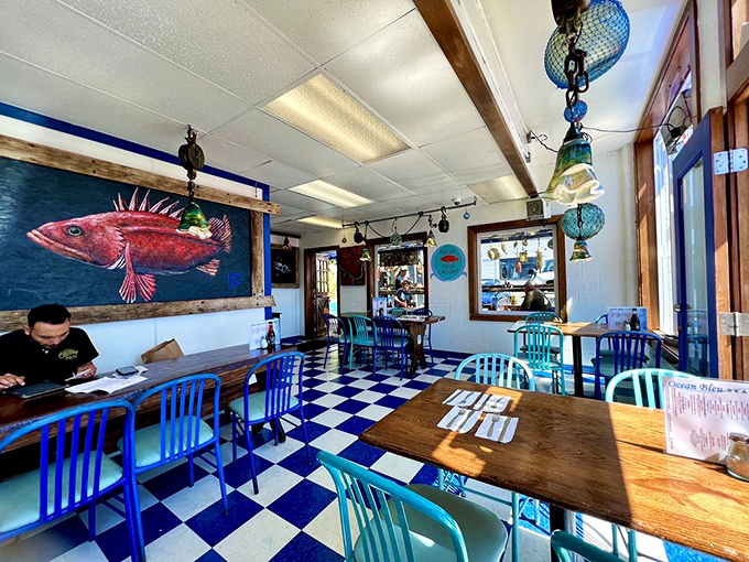 Inside, the checkerboard floor and vibrant blue chairs create a maritime wonderland where that magnificent red fish artwork isn't just decoration &ndash; it's practically the restaurant's spirit animal watching over your meal.