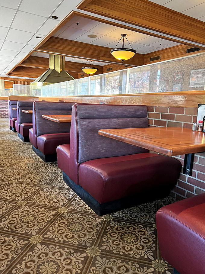 Those burgundy booths have witnessed more celebrations than a wedding DJ. The patterned carpet practically whispers "steak time."