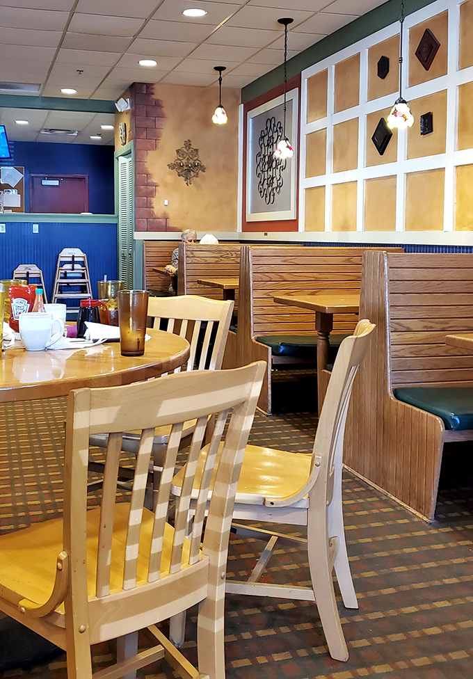 Cozy wooden booths and warm yellow walls create that perfect diner atmosphere&mdash;where conversations flow as freely as the coffee refills.