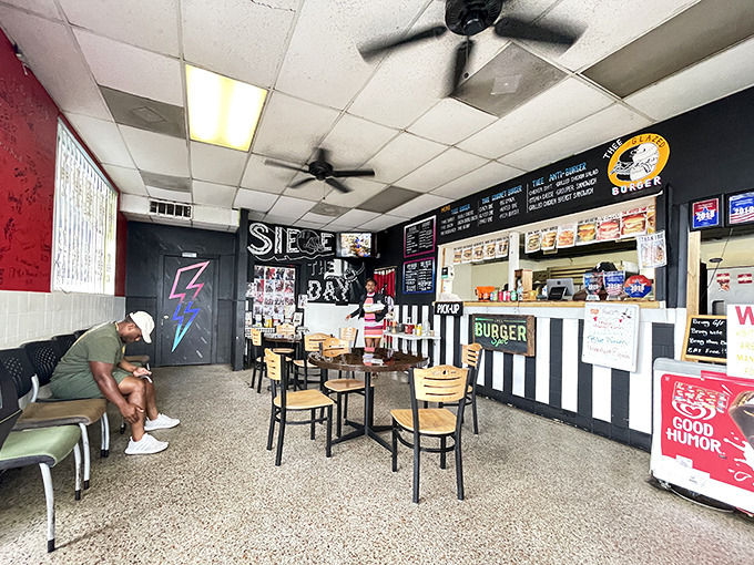 Inside, the black and white checkered counter backdrop creates a no-nonsense diner vibe where the food does the talking and ceiling fans keep the Florida heat at bay.
