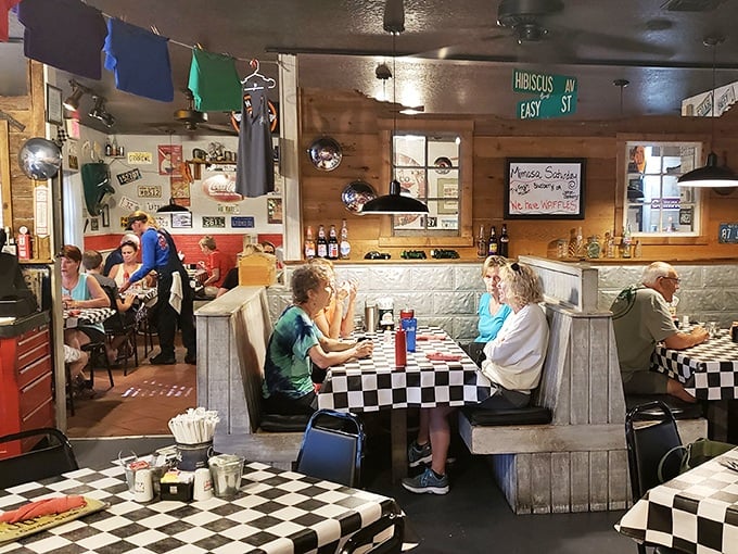 Inside, the warm wood paneling and checkered tablecloths create that perfect diner atmosphere where conversations flow as freely as the coffee.