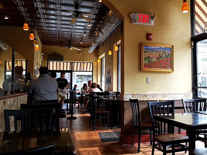 Warm golden walls, exposed ductwork, and that Tuscan landscape painting&mdash;this isn't just a restaurant, it's a portal to Italy without the jet lag.