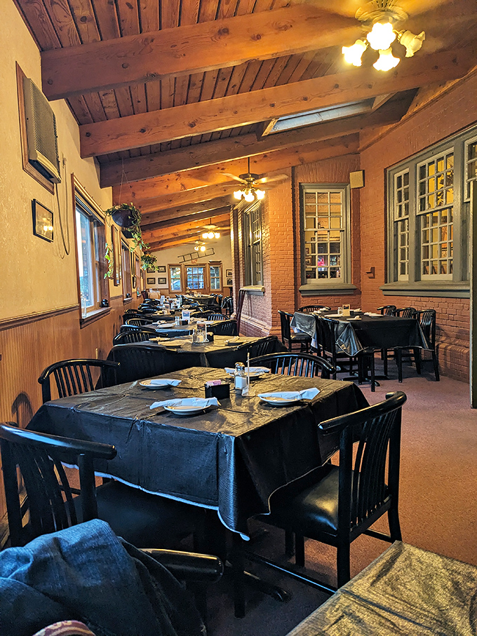 Exposed wooden beams, brick walls, and black tablecloths create the perfect blend of rustic charm and dining elegance. Railroad dining never looked so inviting.