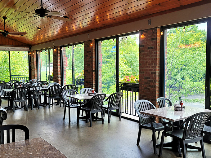 The screened porch at Ron's Roost offers a serene dining experience, where wooden ceilings and natural light create the perfect backdrop for chicken-induced euphoria.