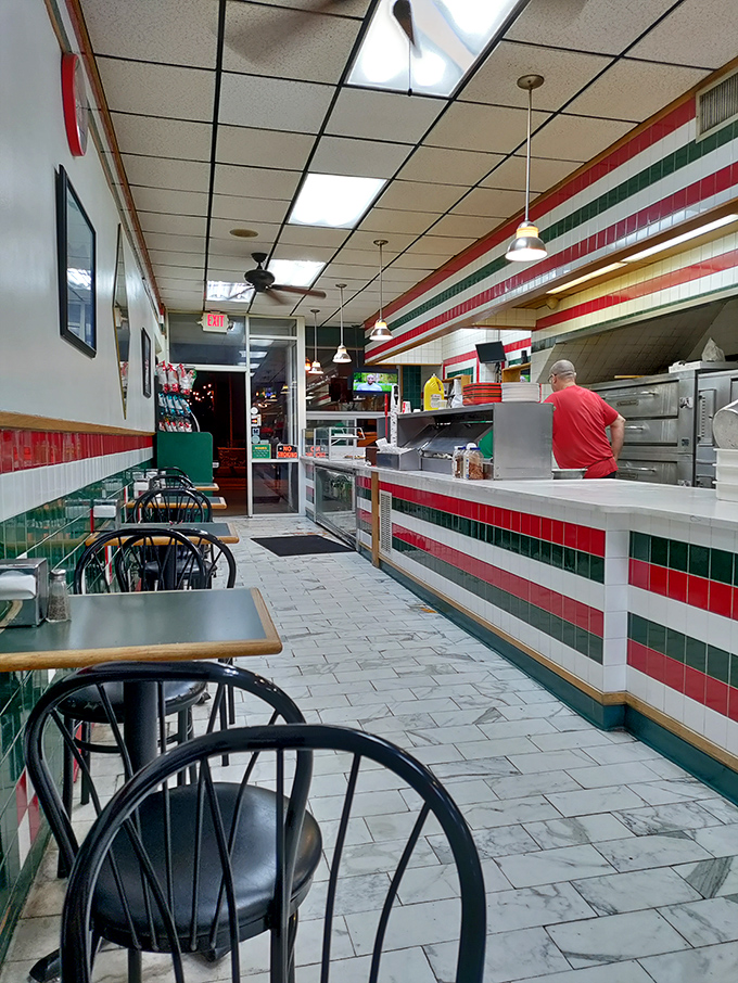 Classic Italian flag colors line the walls where pizza magic happens. The narrow, no-frills interior speaks volumes: focus on the food, not the decor.