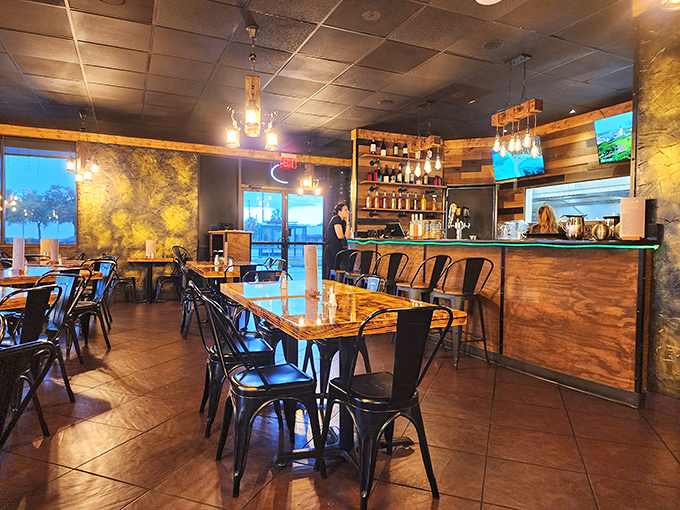 Industrial meets warmth in Le&ntilde;a's dining space, where wood-paneled walls and amber lighting create the perfect backdrop for meat-induced euphoria. 