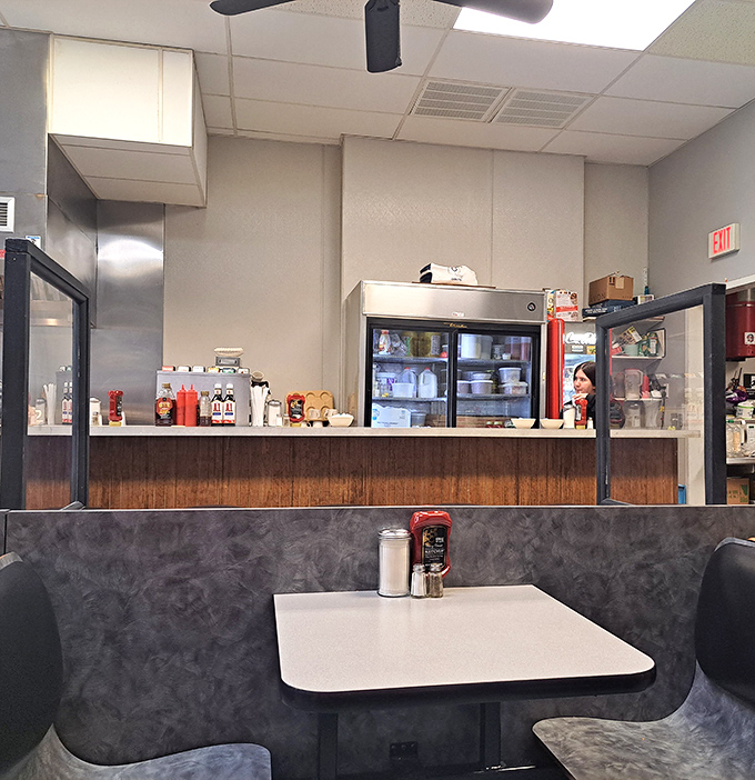Classic diner booths where countless life decisions have been made over coffee refills. The wood paneling isn't retro &ndash; it's authentic, because it never left.