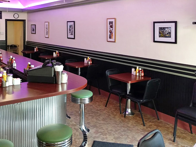 Purple lighting and classic booths create that perfect diner atmosphere where time slows down and conversation flows freely.