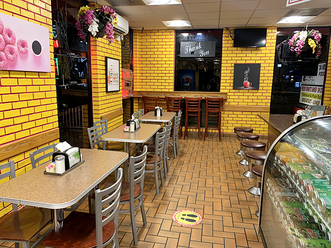 Yellow brick walls and no-nonsense tables create the perfect backdrop for serious donut contemplation. Simplicity at its sweetest.