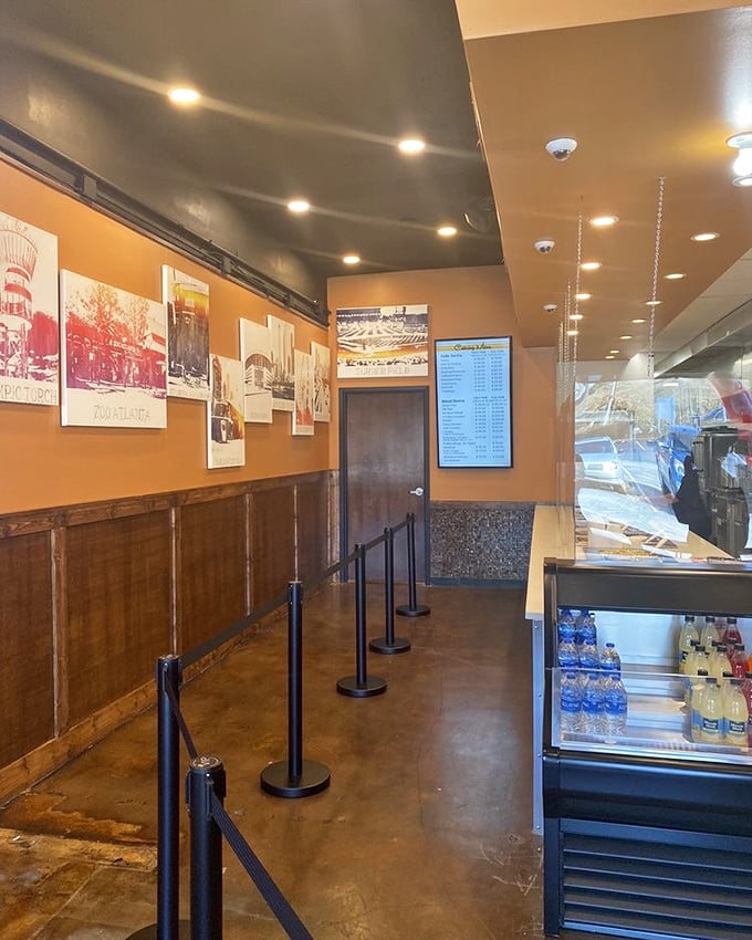 The warm orange walls and historic photos create that rare atmosphere where you instantly feel like a regular, even on your first visit.