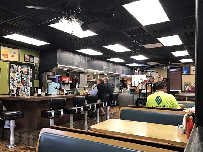 The classic diner interior where magic happens. Counter seats offer front-row tickets to the culinary show that locals line up for.