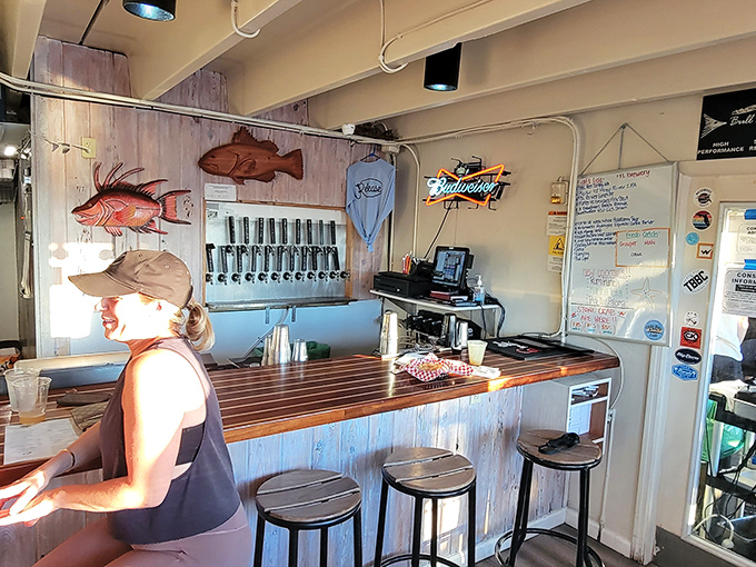 Nautical charm meets casual comfort at the bar, where wooden fish sculptures watch over patrons like aquatic guardian angels of good taste.