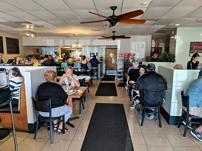 Inside, ceiling fans lazily spin above a bustling dining room where locals gather. The hum of conversation is the soundtrack to your morning feast.