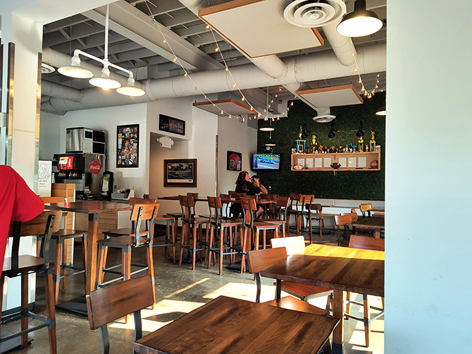 Industrial-chic meets comfort in this no-frills dining space. The exposed ceiling and string lights say, "We saved our energy for the chicken."